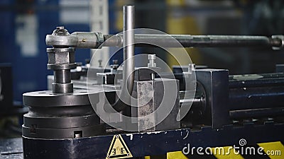 A Worker in Production Bends a Metal Pipe Using a Special Pipe Bending ...