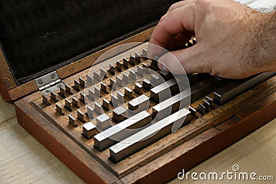 The Worker Takes The Measuring Gage Blocks For Measurement Stock Photo ...