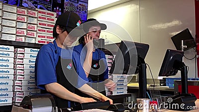 Worker Taking Phone Call for Customer Ordering Domino Pizza Stock ...