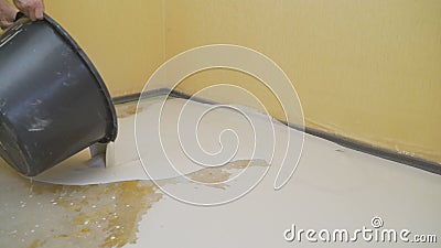 Workers Flood the Floor. Liquid Flooring. Leveling the Floor with a ...