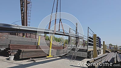 Workers Unload a Metal in a Truck Standing Under a Gantry Crane ...