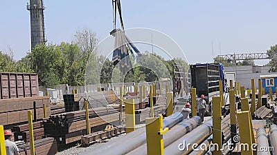 The Working Process in a Warehouse with a Metal. Workers Unload a Metal ...