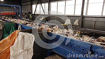 Workers At The Waste Processing Plant. Sorting Trash On A Conveyor Belt ...