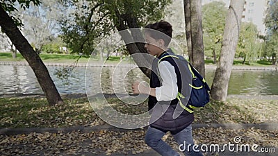 10 Year Caucasian Boy Is Late For Classes At School. Boy Is Running At ...