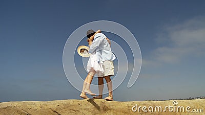 Young Couple Kissing on Berm at Beach and Falling Off Stock Footage ...