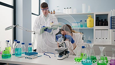 Young Couple Wearing Scientist Uniform Using Microscope Working at ...
