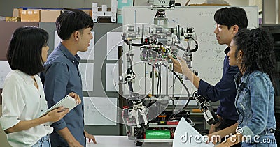 Young Electronics Engineer Team Collaborating on Construction of Robot ...