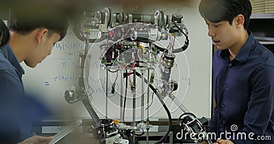 Young Electronics Engineer Team Collaborating on Construction of Robot ...