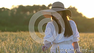 A Young Girl Walking in Slow Motion through a Wheat Field. Stock ...