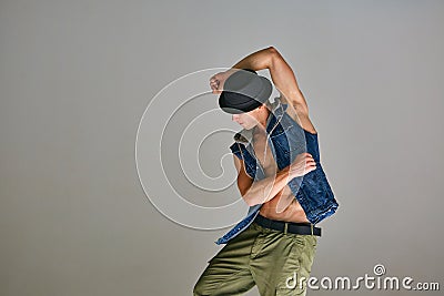 Young Guy Breakdancer In Hat Dancing Hip-hop In Studio Isolated On Gray ...