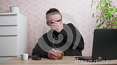 Young Guy Sitting at a Computer Watching a Scary Movie, Sitting at a ...