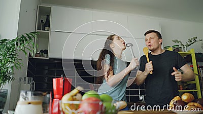 Young Joyful Couple Have Fun Dancing and Singing while Cooking ...