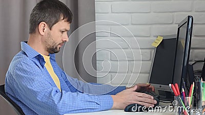 The Young Man Crouched at a Workplace with a Computer and Started Work ...