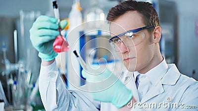 A Young Man Doing an Experiment in a Chemical Laboratory Stock Video ...