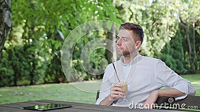 A Young Man Drinking Milkshake in the Park Stock Footage - Video of ...