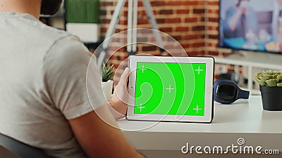 Young Man Holding Modern Device with Horizontal Greenscreen Template ...