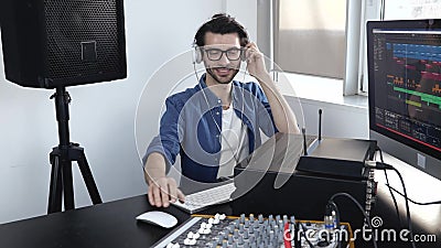 Young Man in Sound Recording Studio. Sit at Table and Adjusting Mixing ...