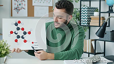 Young Man Teaching Chemistry in Remote Class Speaking Showing Visual ...