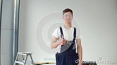 Young Master in Work Uniform and with a Set of Tools Stands on a White ...