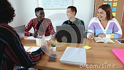 Young Multiracial Students Reading Books and Using Laptop in Classroom ...