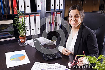 Young Office Worker Girl Dressed In A Suit Sitting At Desktop Stock ...