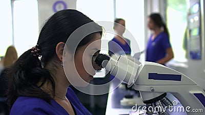 Young Pretty Woman Doing Analysis in the Laboratory Using Microscope ...