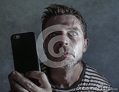 Young Weird And Crazy Mobile Phone Addict Man Using Cell Compulsively ...