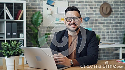 Zoom-in Portrait of Attractive Guy Using Laptop Then Looking at Camera ...