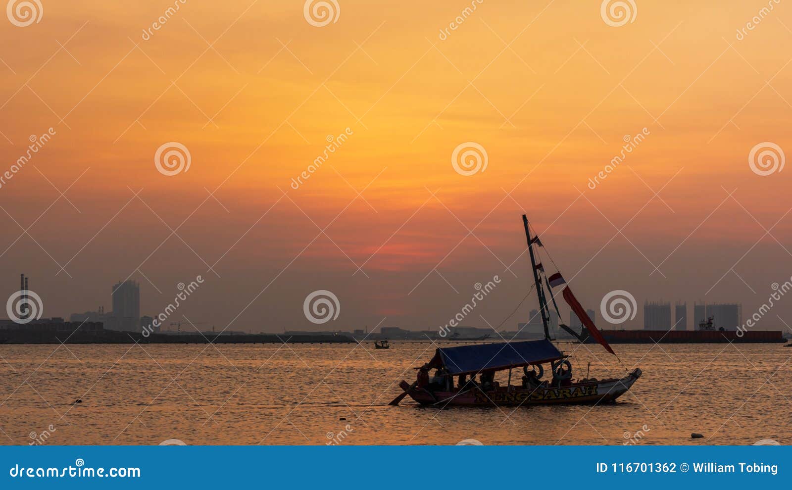 Sunset with Yellow Orange Color Sky and Silhouette of Boat. Ancol Beach ...