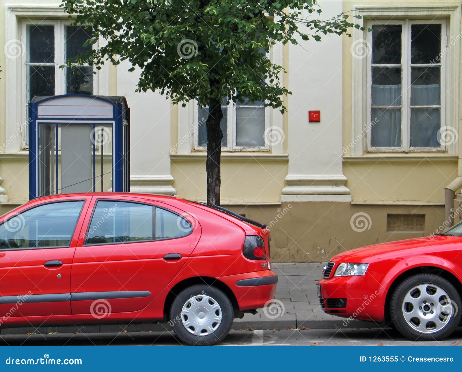 2 cut red cars on parking stock image. Image of phone - 1263555