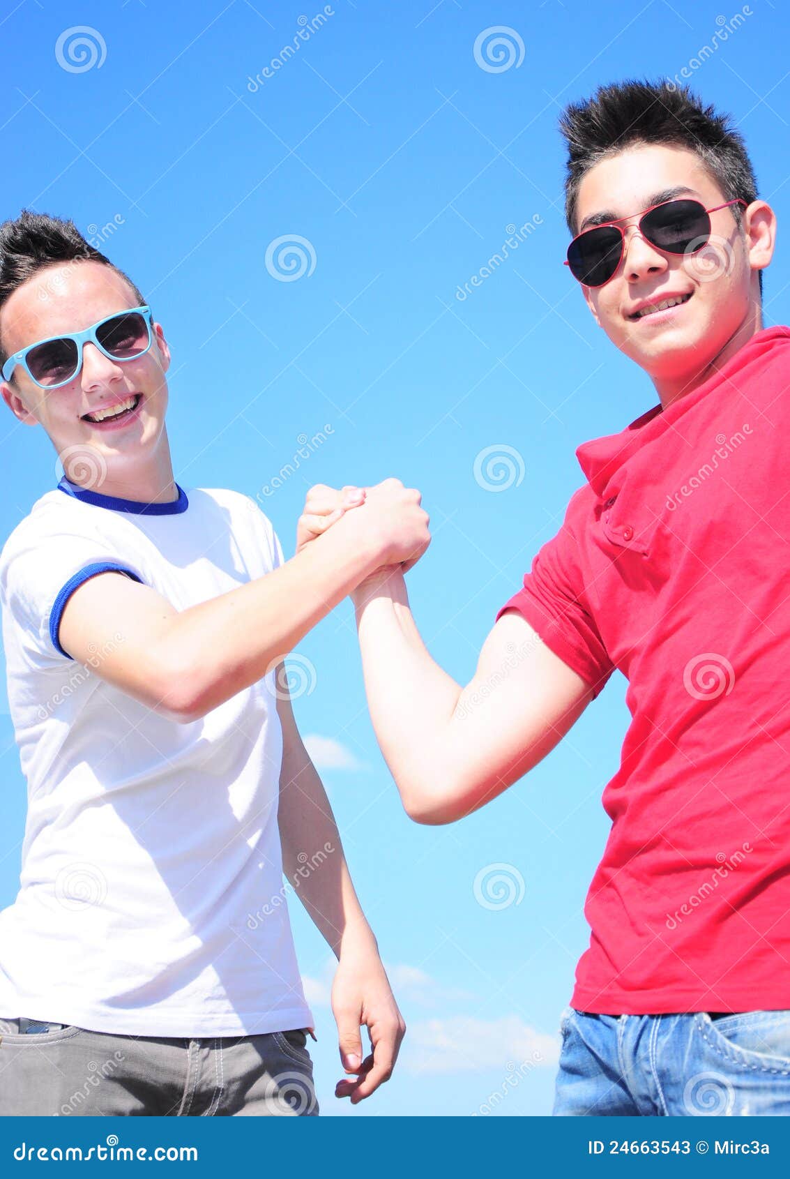 2 teen boys shaking hands stock image. Image of portrait - 24663543