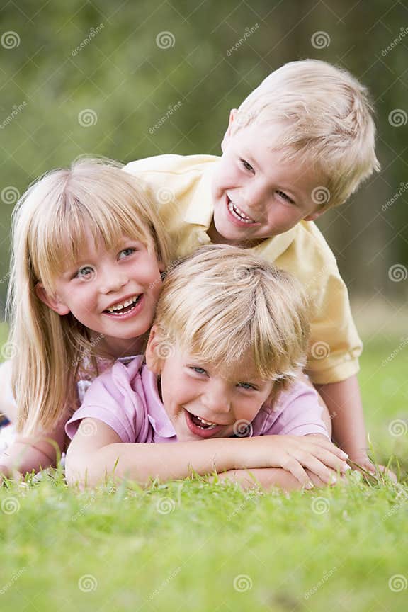 3 children playing outside stock image. Image of siblings - 4850109