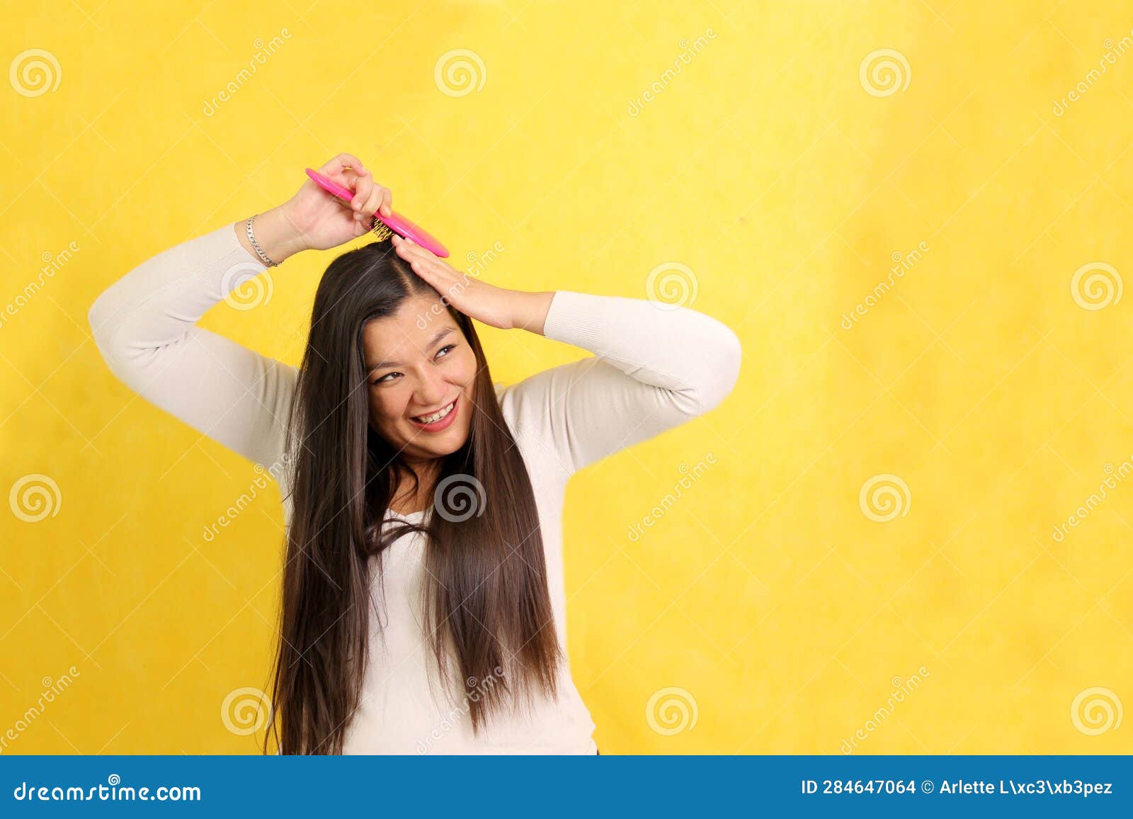 40 Year Old Latina Woman Brushes Her Straight Hair With Difficulty