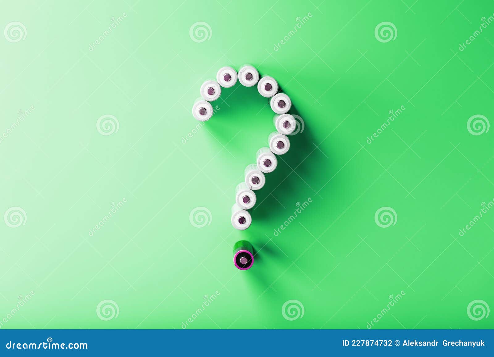 AA Batteries in the Form of a Question Mark on a Green Background with ...