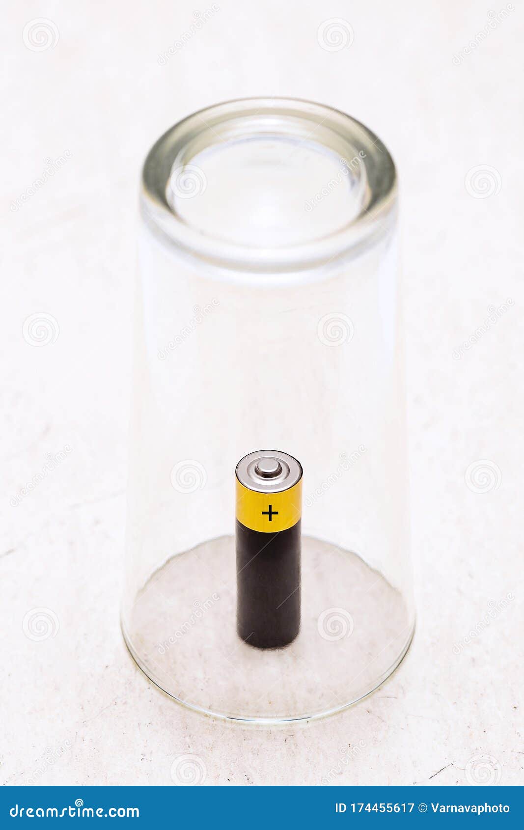 AA Battery is Covered with Glass Cup. Energy Conservation and ...