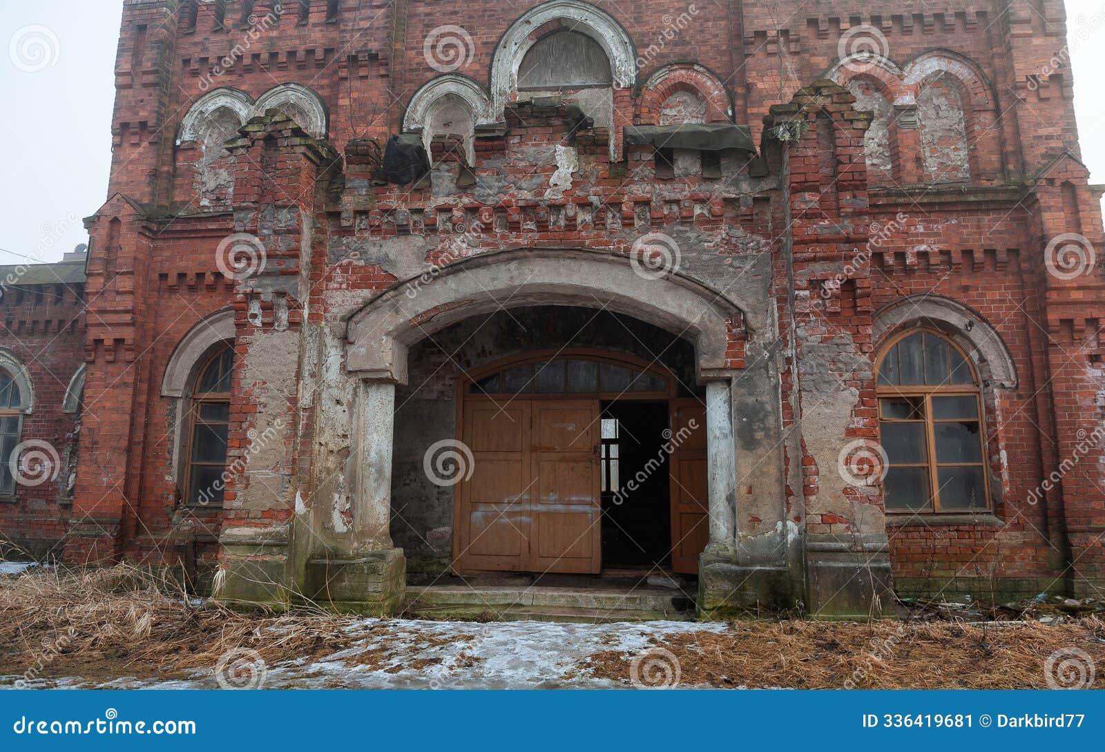 Abandoned Brick House with a Decayed Wall and Broken Window in a Misty ...