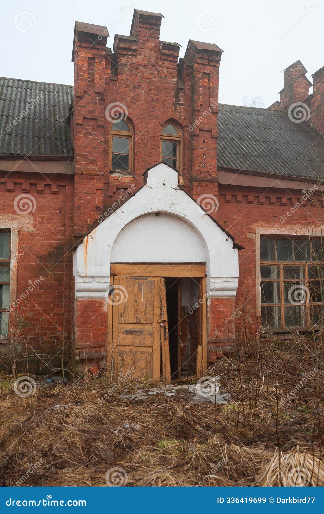 Abandoned Brick House with a Decayed Wall and Broken Window in a Misty ...