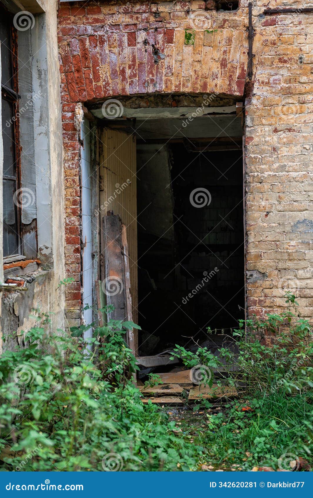 Abandoned Broken Door Leads into a Decayed Building with Brick Walls ...