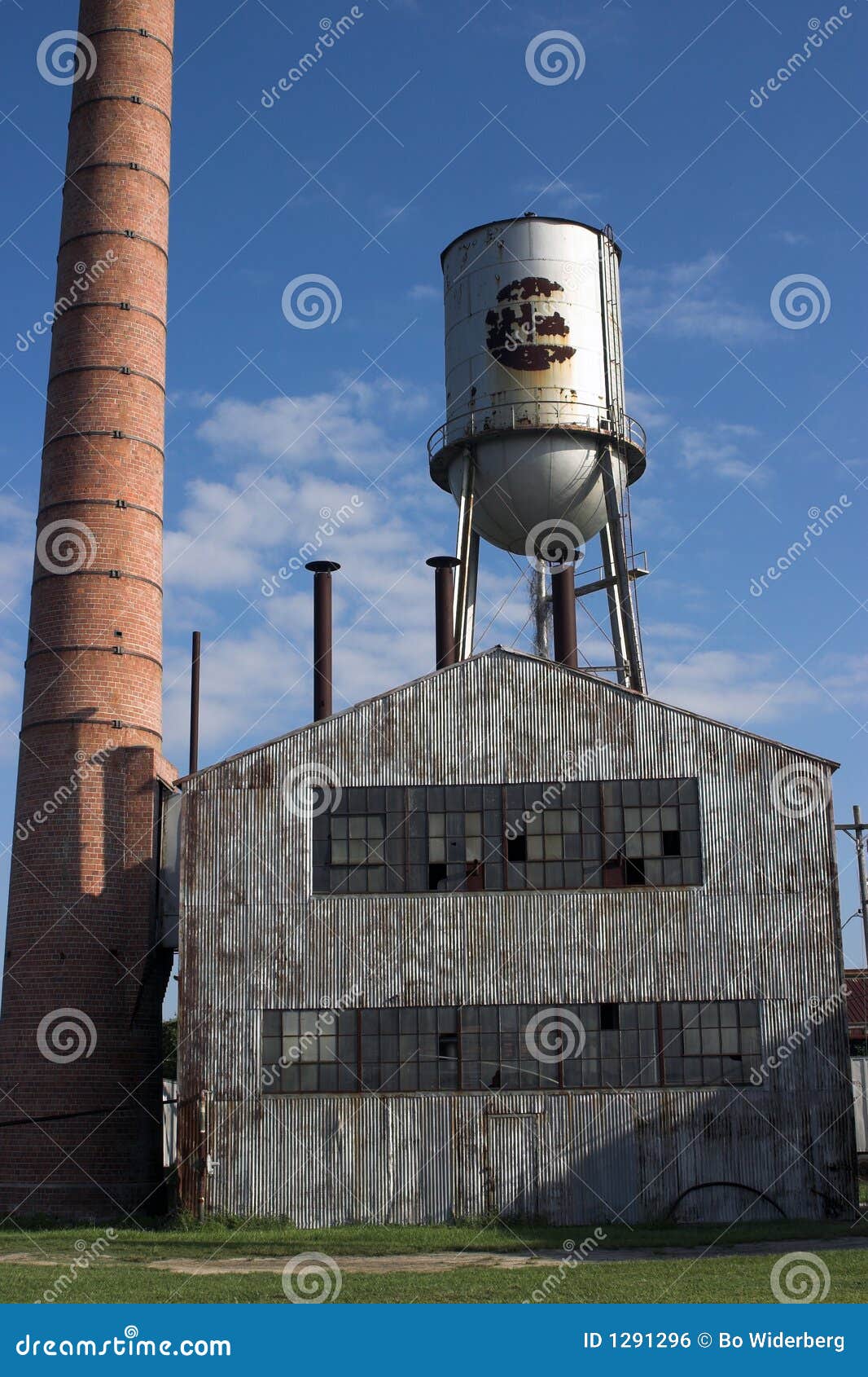 Abandoned Factory Building with Water Tower and Chimney Stock Photo ...