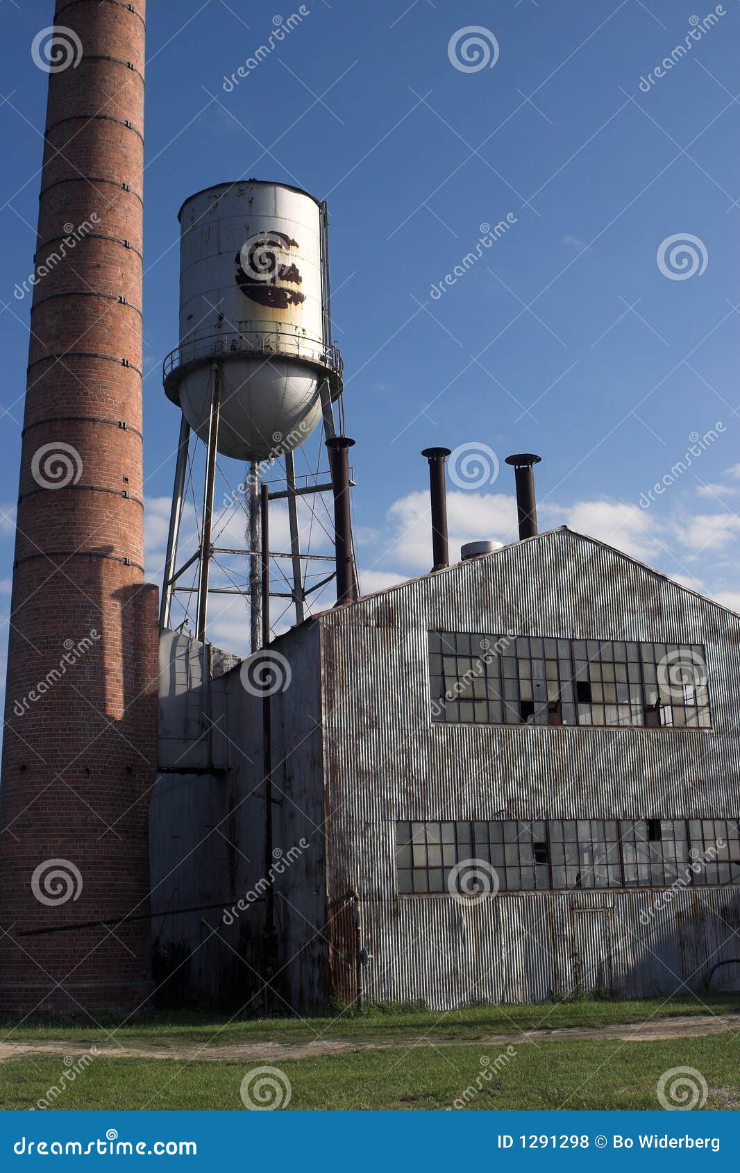 Abandoned Factory Building with Water Tower and Chimney Stock Photo ...