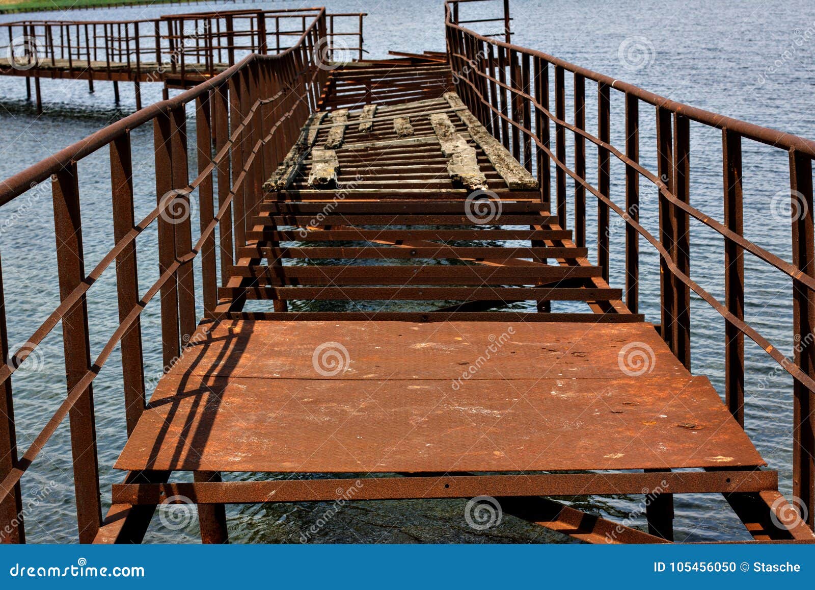 The Abandoned Old Rusty Iron Bridge Across the Water Stock Photo ...