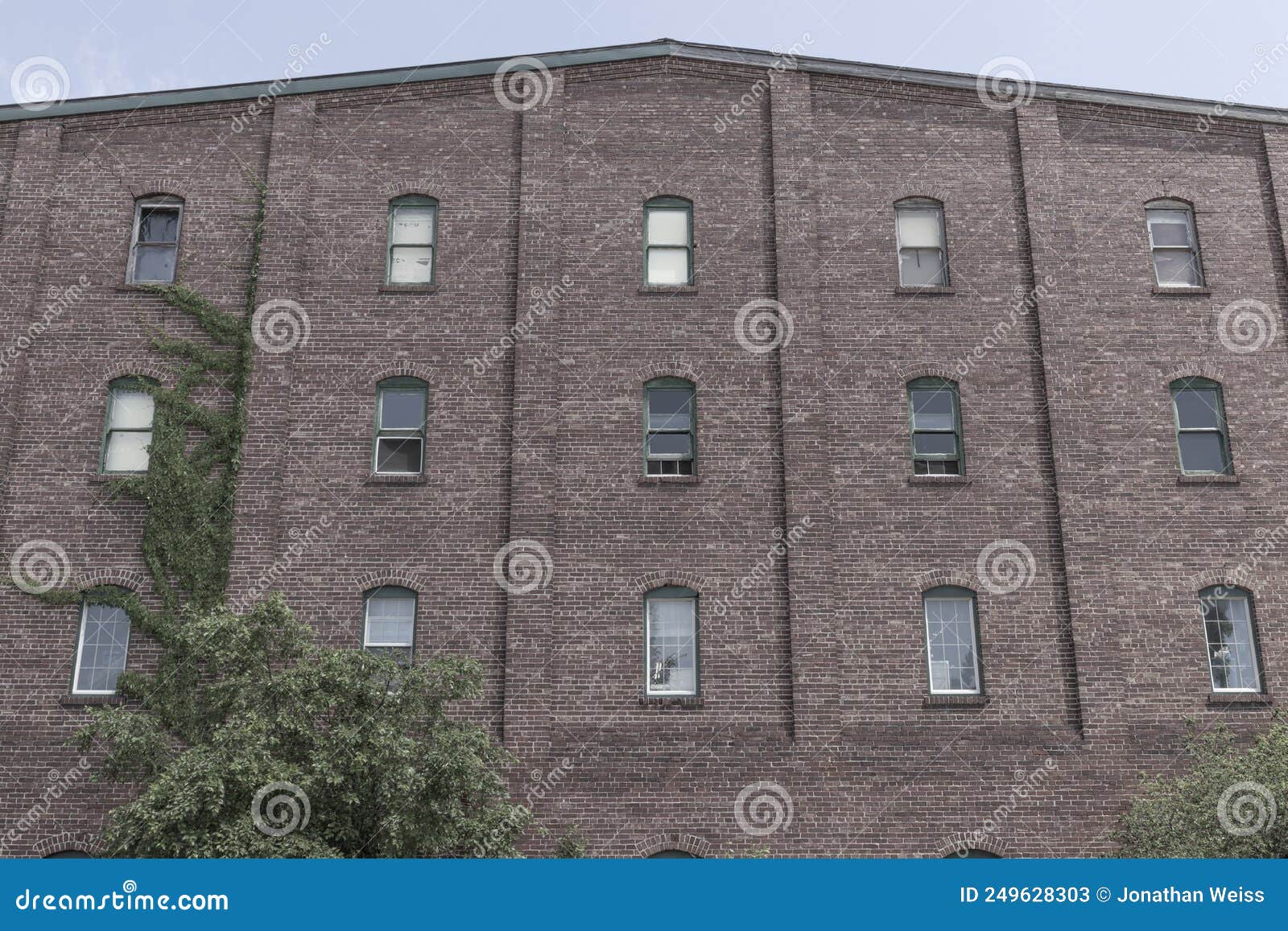 Abandoned Rust Belt Auto Warehouse and Factory with Worn Brick Facade ...