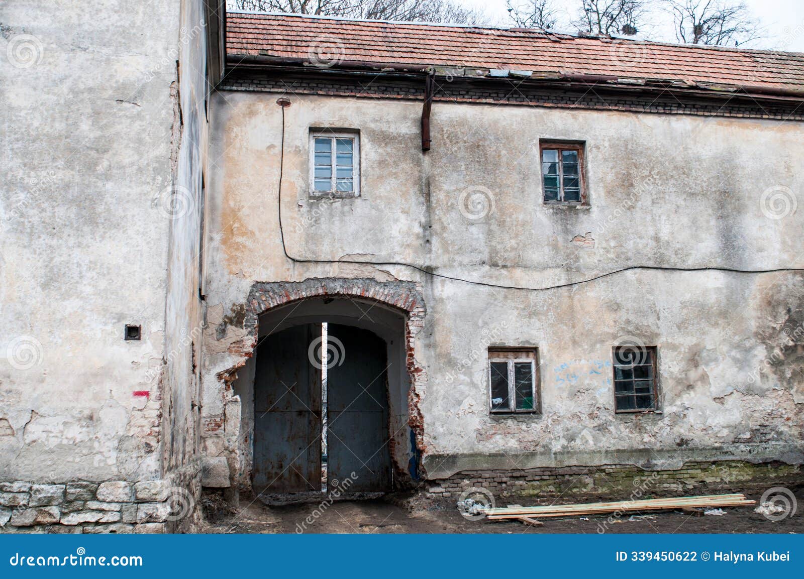 Abandoned Rustic Building with Weathered Stone Walls and a Rusty Gate ...