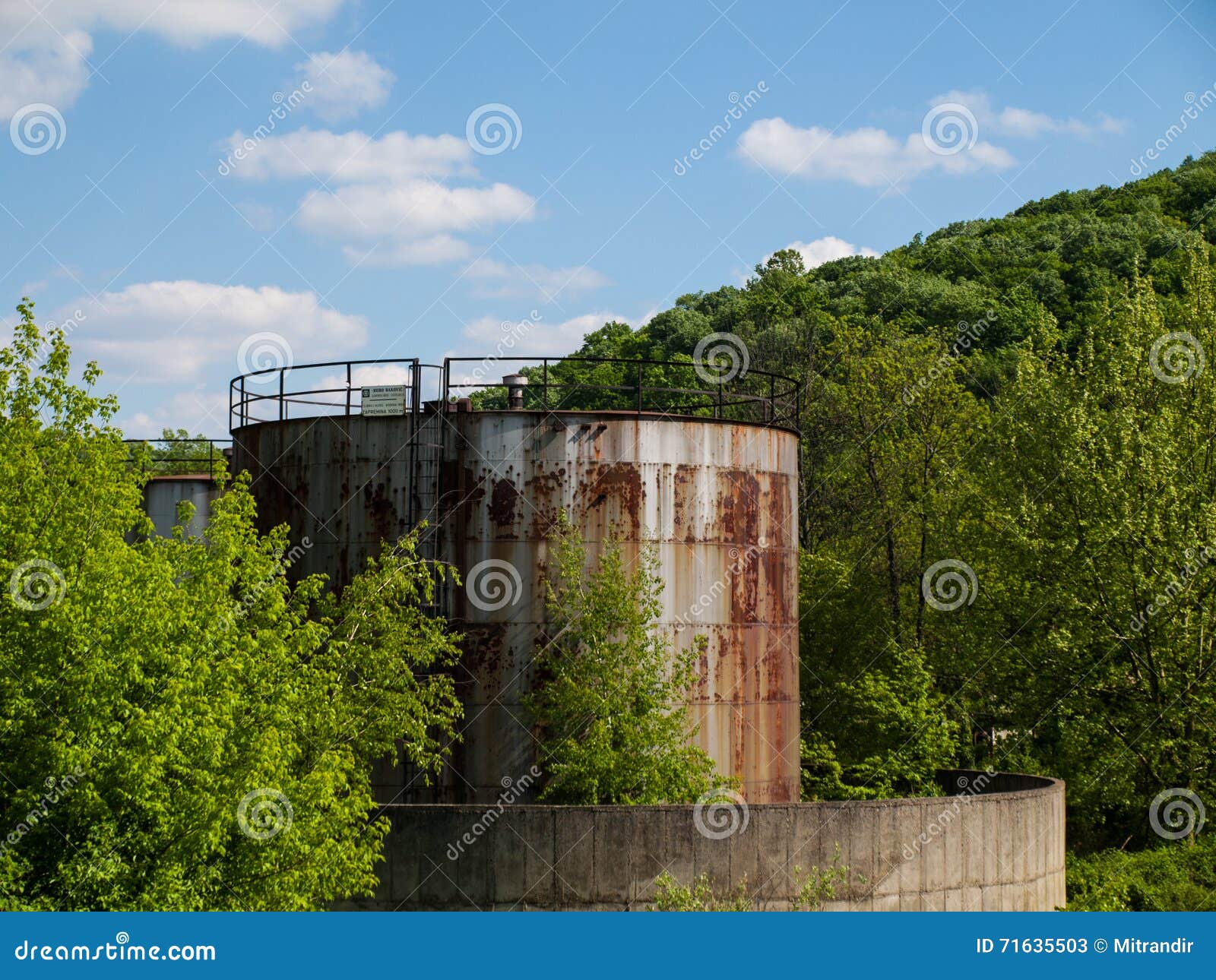 Abandoned Rusty Metal Silo with Concrete Wall Stock Image - Image of ...