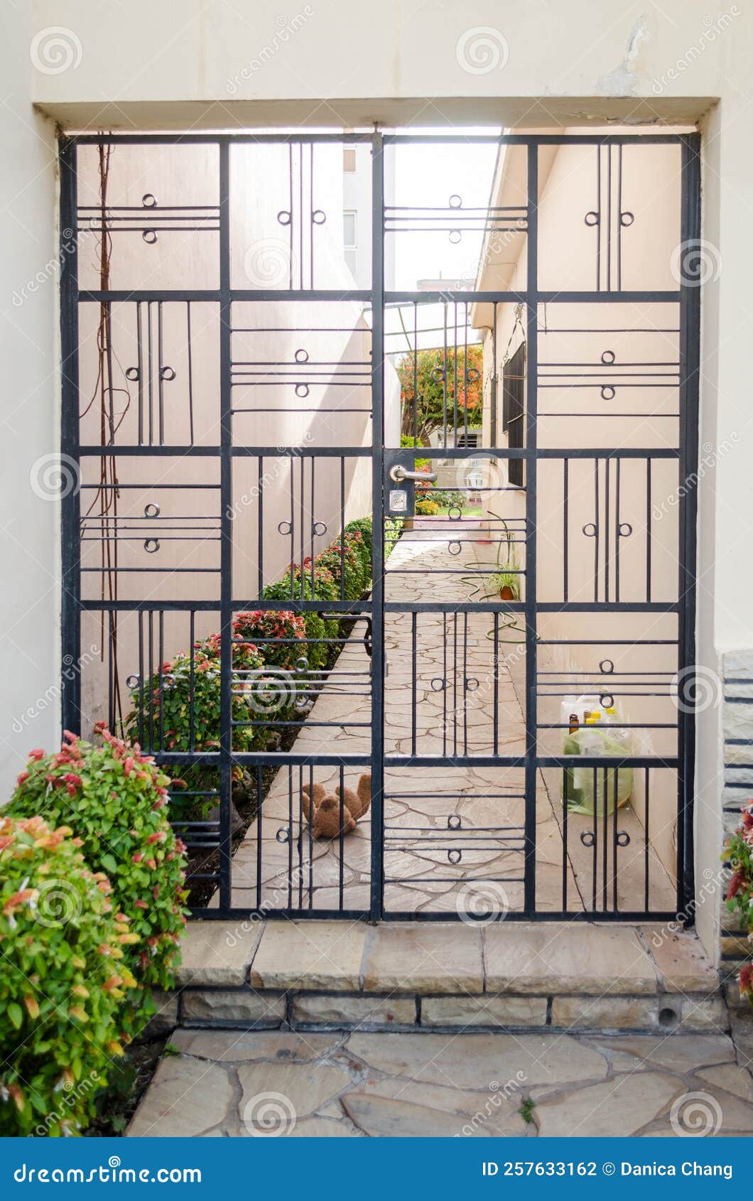 Abandoned Stuffed Bear in a Stone Walkway Behind a Gate Stock Photo ...