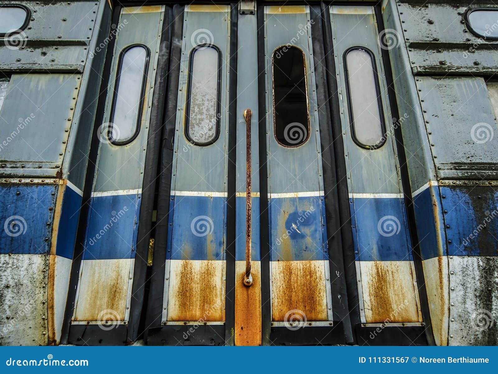 Abandoned Trolley Cars In Fall With Ominous Sky In Field With Rails ...
