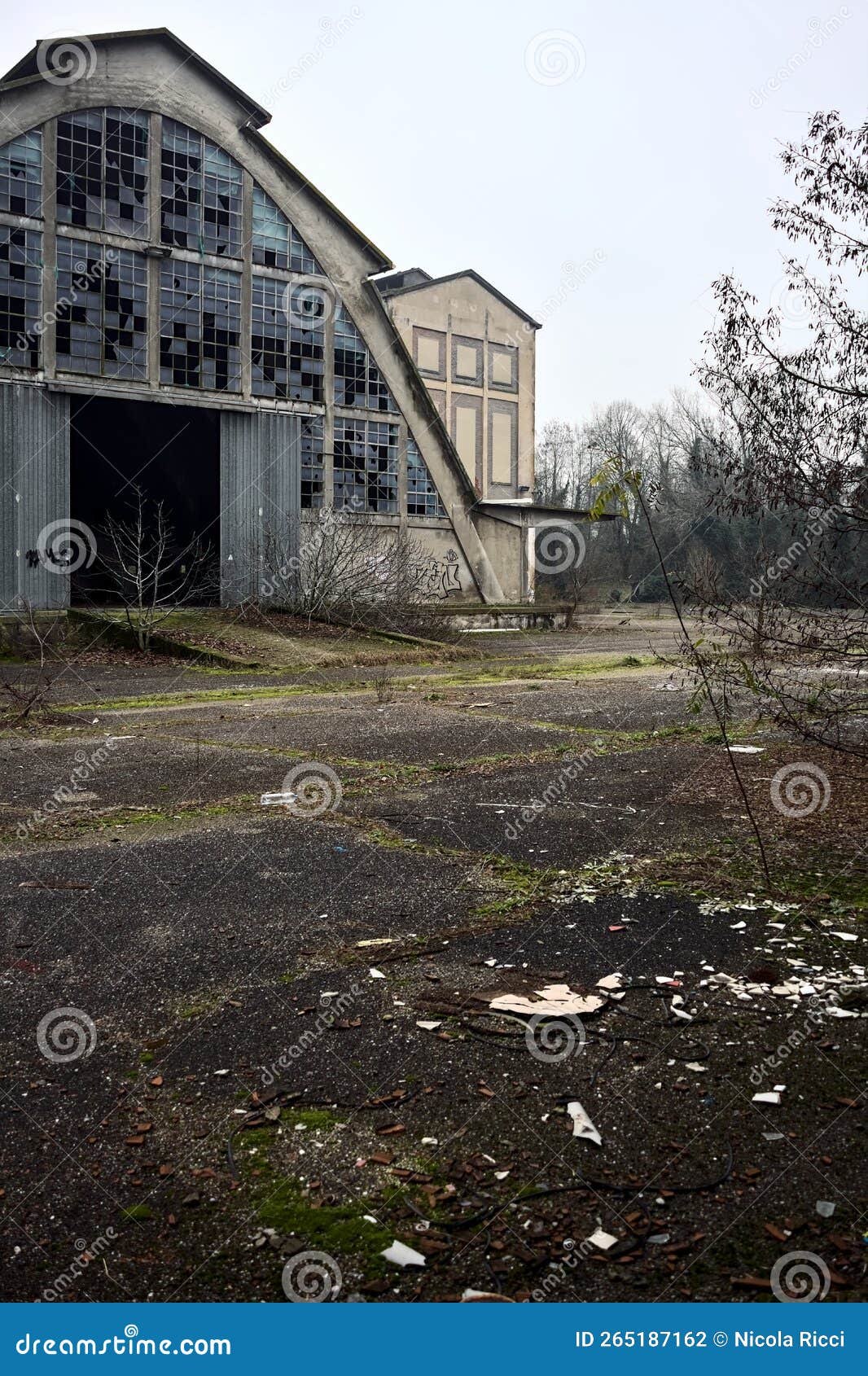 Abandoned Warehouse with Broken Windows in a Park on a Cloudy Day in ...