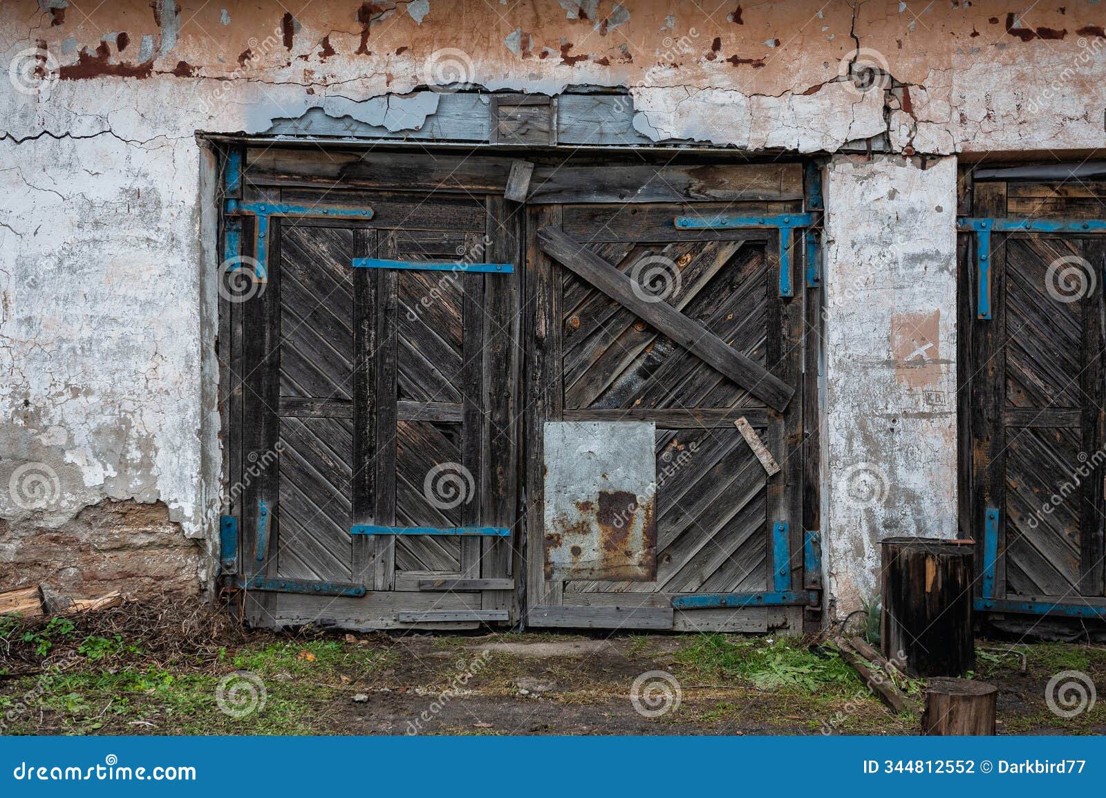 Abandoned Wooden Gate Leads into a Decayed Building with Brick Walls ...