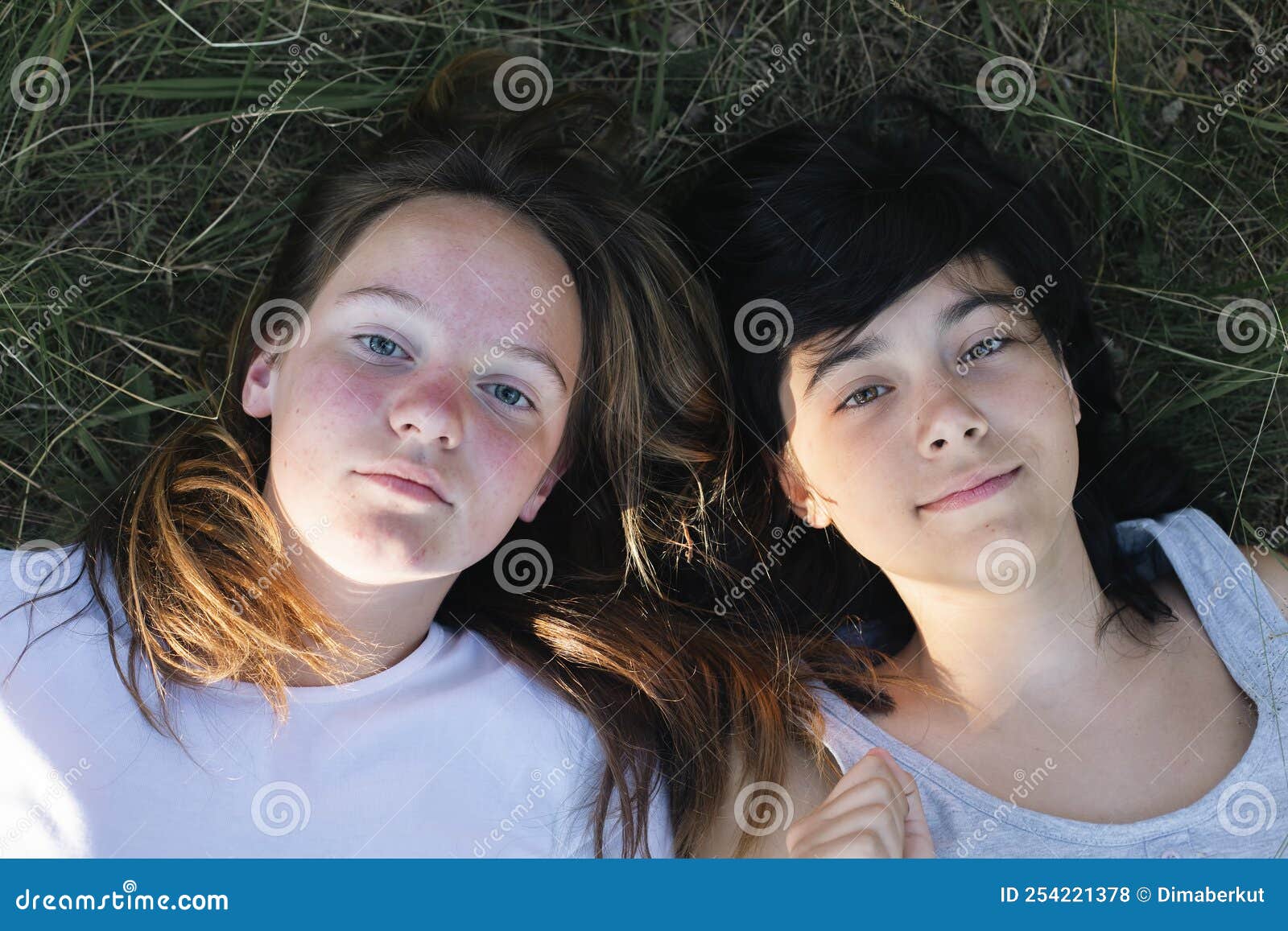From Above of the Two Girls Lying on the Green Grass. Stock Photo ...