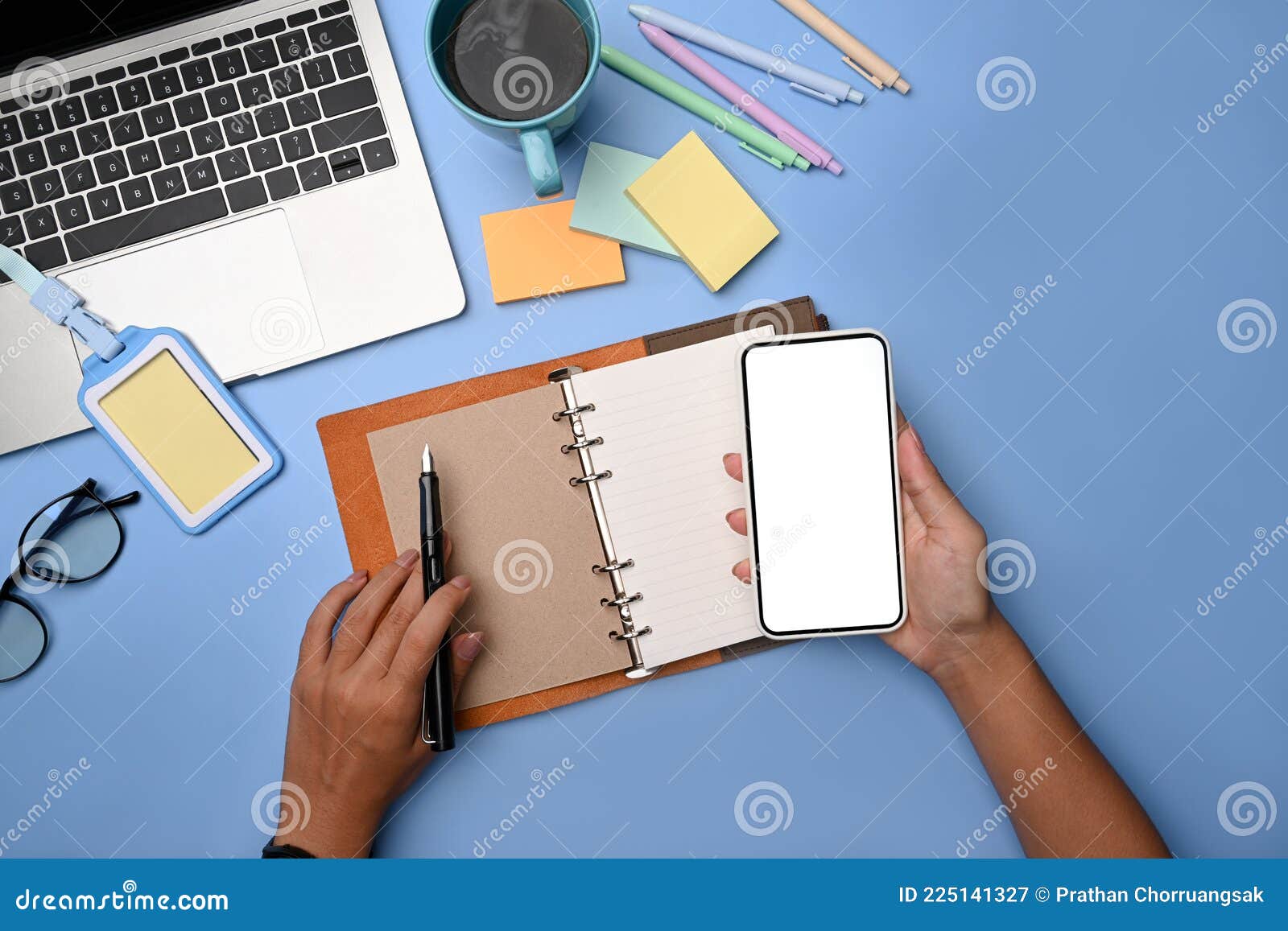 Female Employee Holding Mobile Phone and Making Note on Notebook. Stock ...